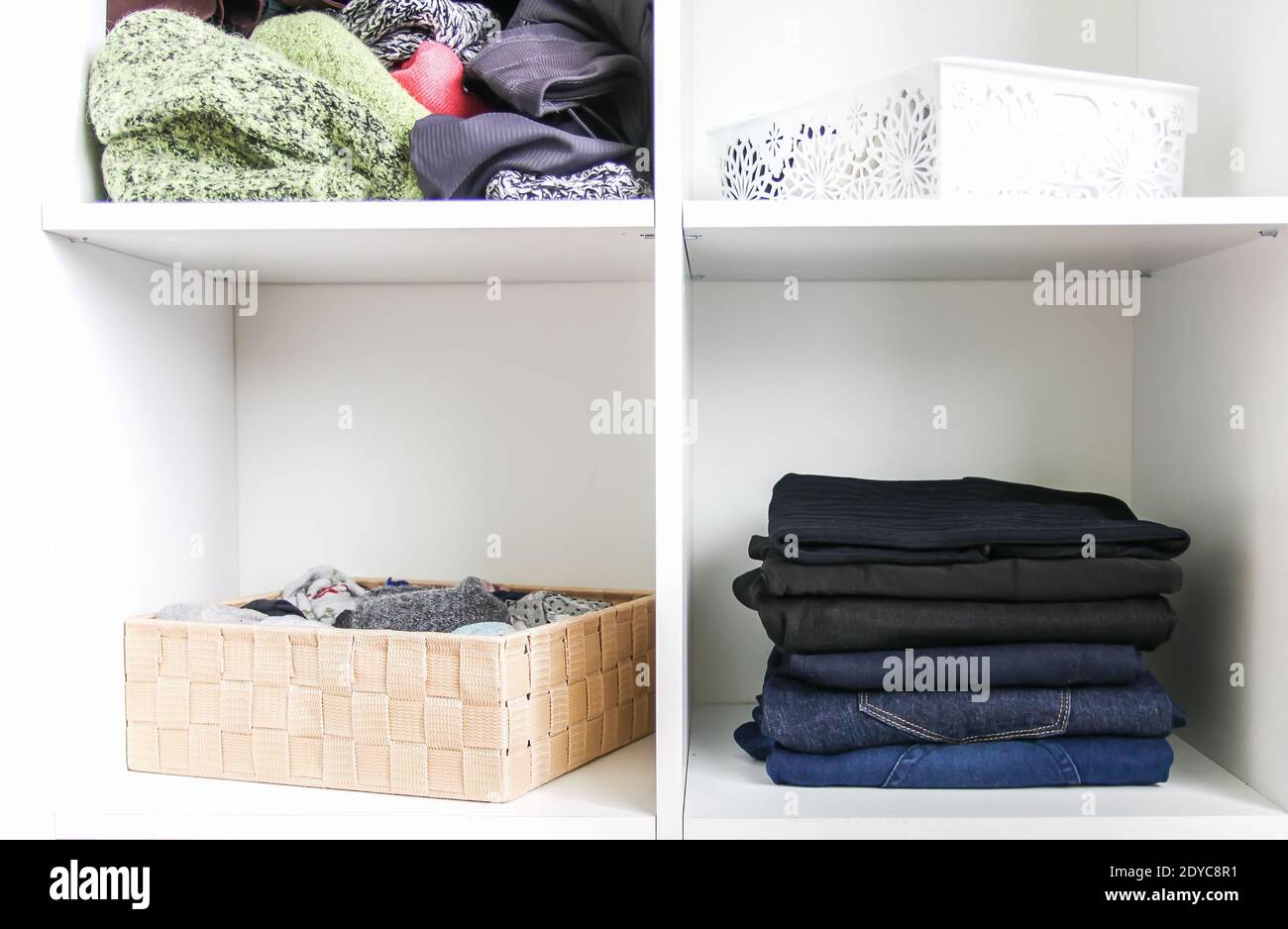 Home wardrobe with different clothes. Small space organization. The ...