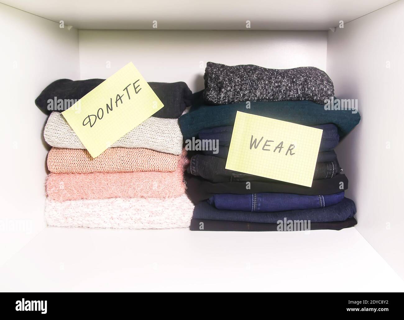 Home wardrobe with different items of clothing. Seasonal clothes ...