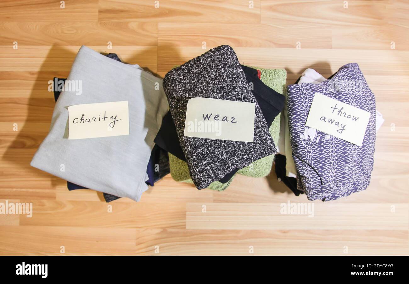 Home wardrobe with different items of clothing. Seasonal clothes ...