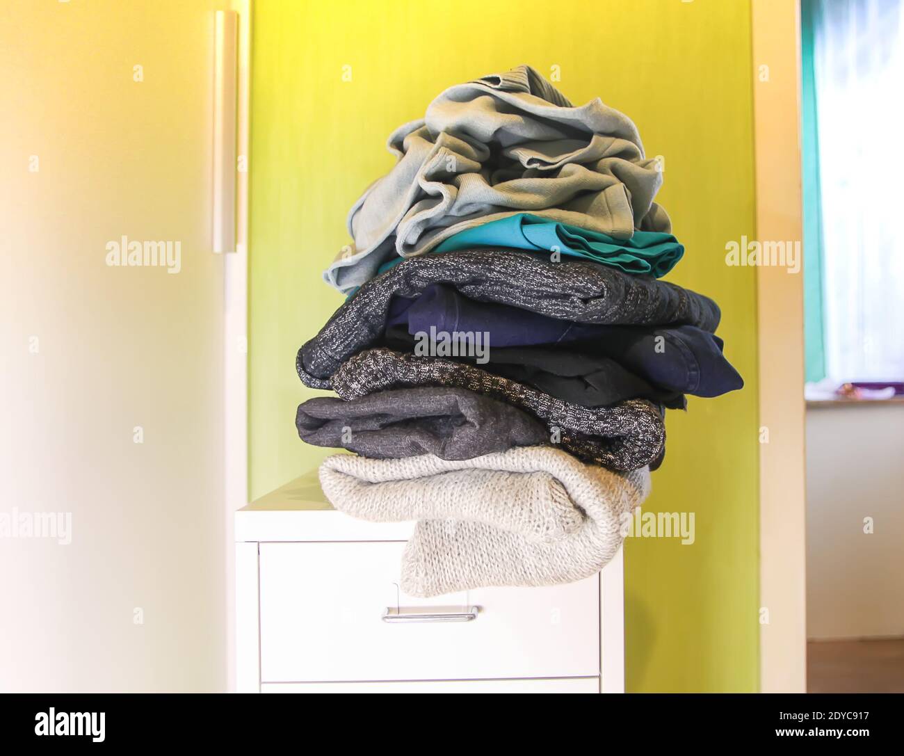 Home wardrobe with different clothes in disorder. Small space ...