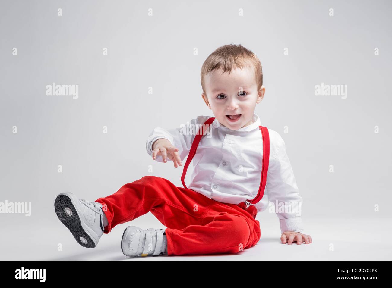 Pretty little boy, dressed in red on white background. Boy and ...