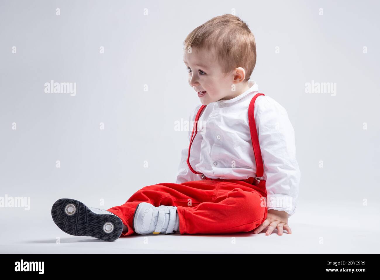 Pretty little boy, dressed in red on white background. Boy and ...