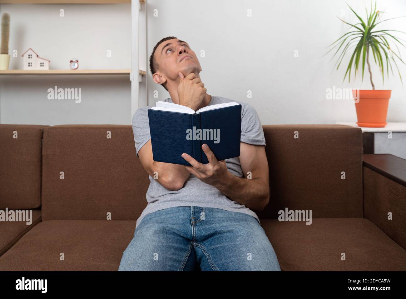 Man reads the Bible and looks up thoughtfully. Search for God Stock ...
