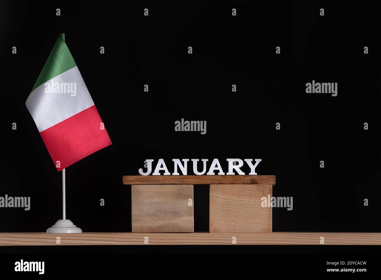 Wooden calendar of January with Italian flag on black background. Dates ...