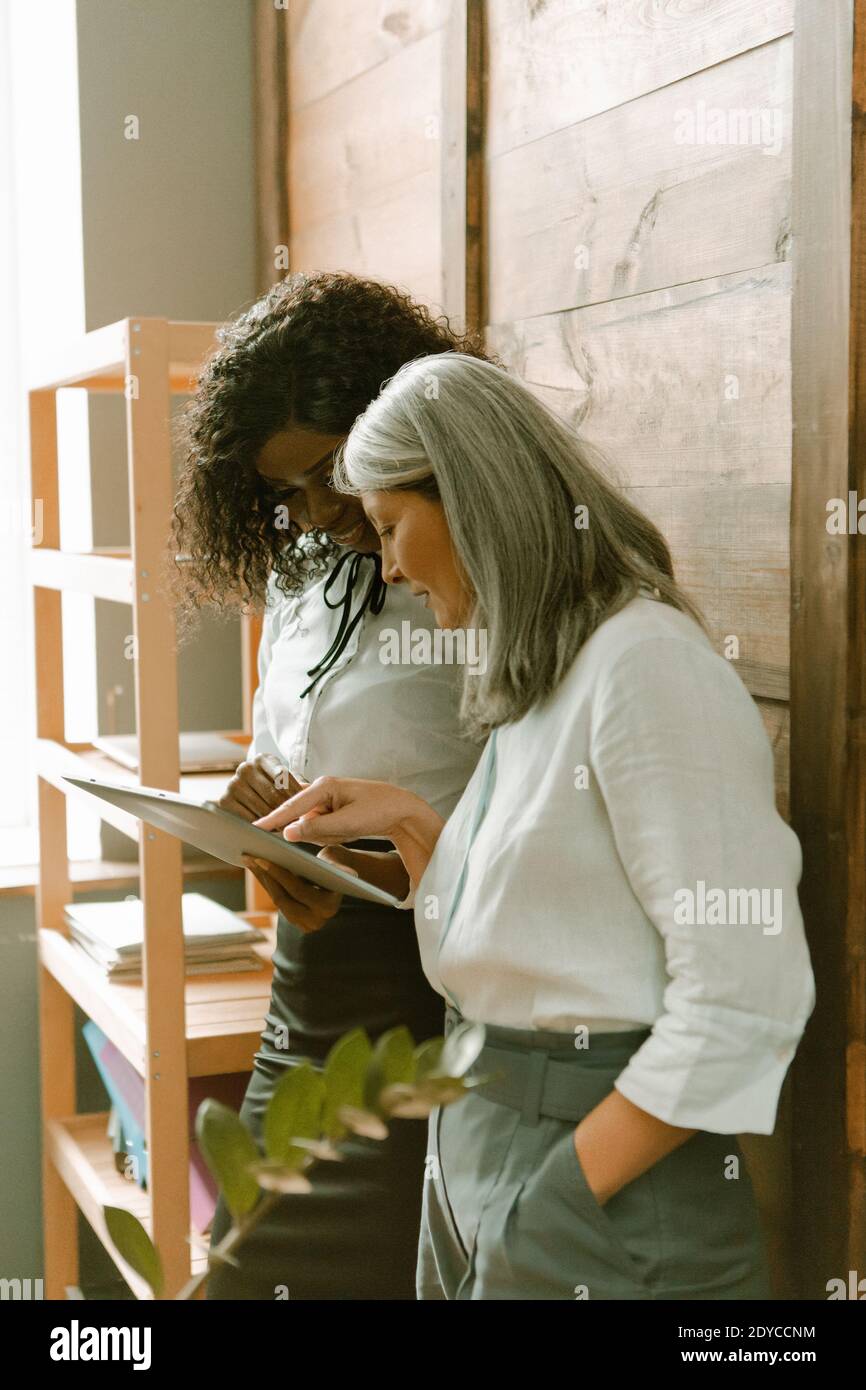 Asian project manager mature woman and young African employee working ...