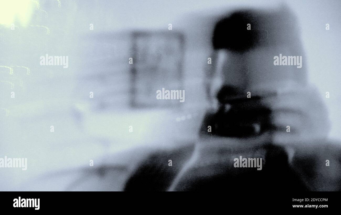 Artistic blurred photo of a photographer taking a selfie in the mirror ...