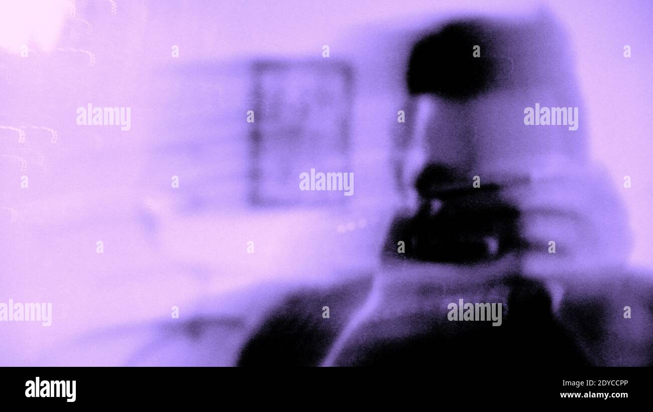 Artistic blurred photo of a photographer taking a selfie in the mirror ...