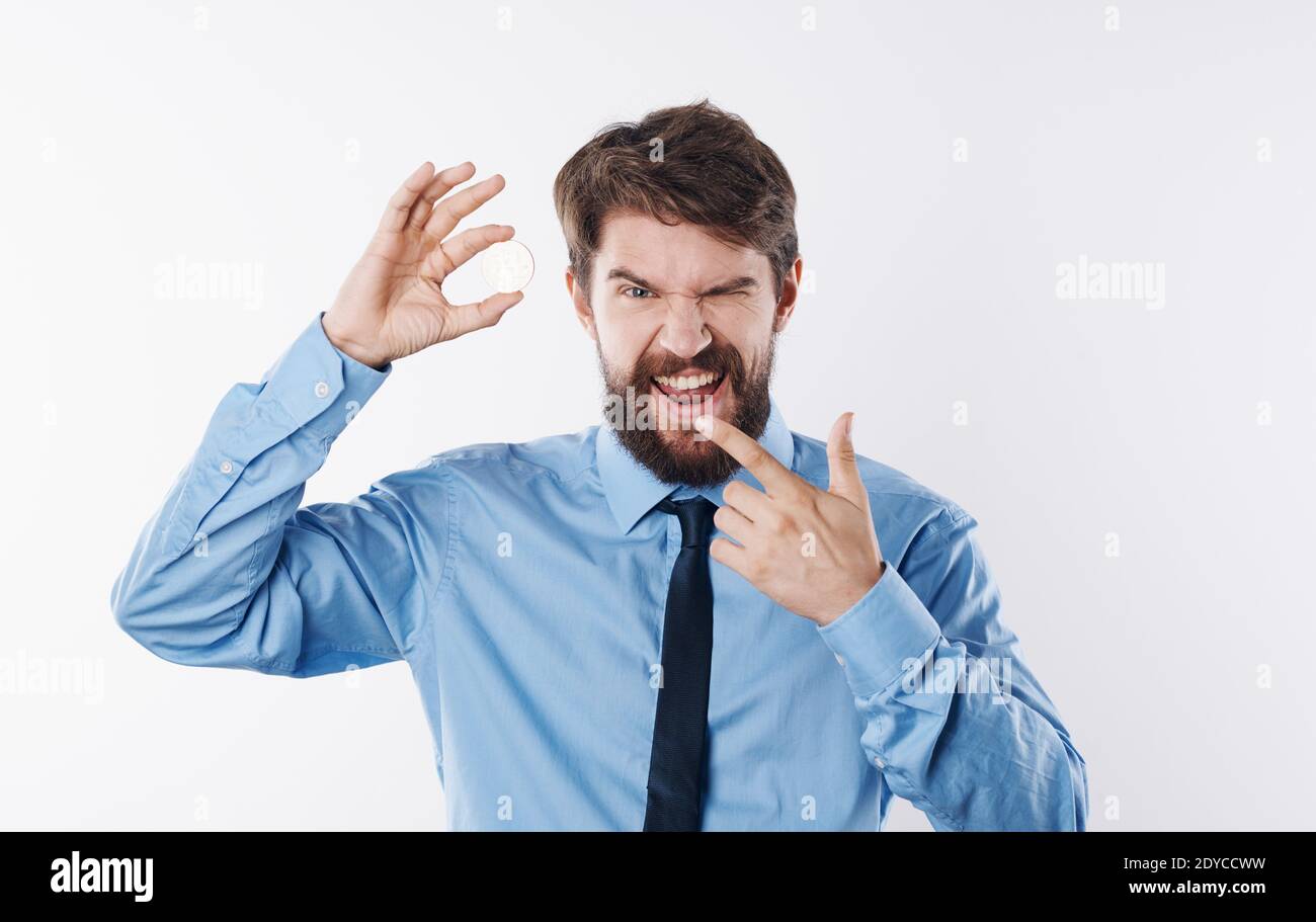 Business man with a coin and in a blue shirt a tie around his neck a ...