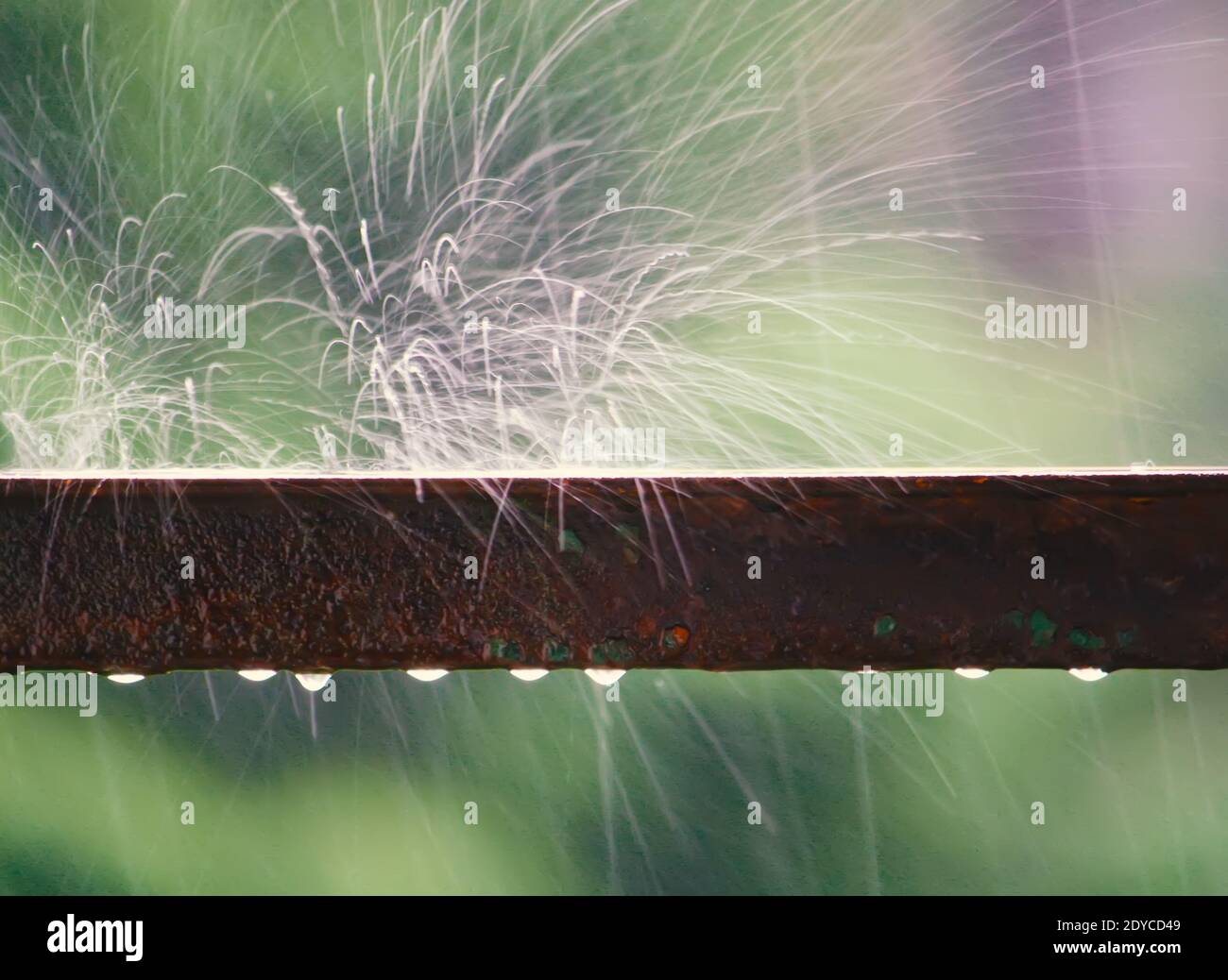 Splash of rain on the irin railings outdoors Stock Photo - Alamy