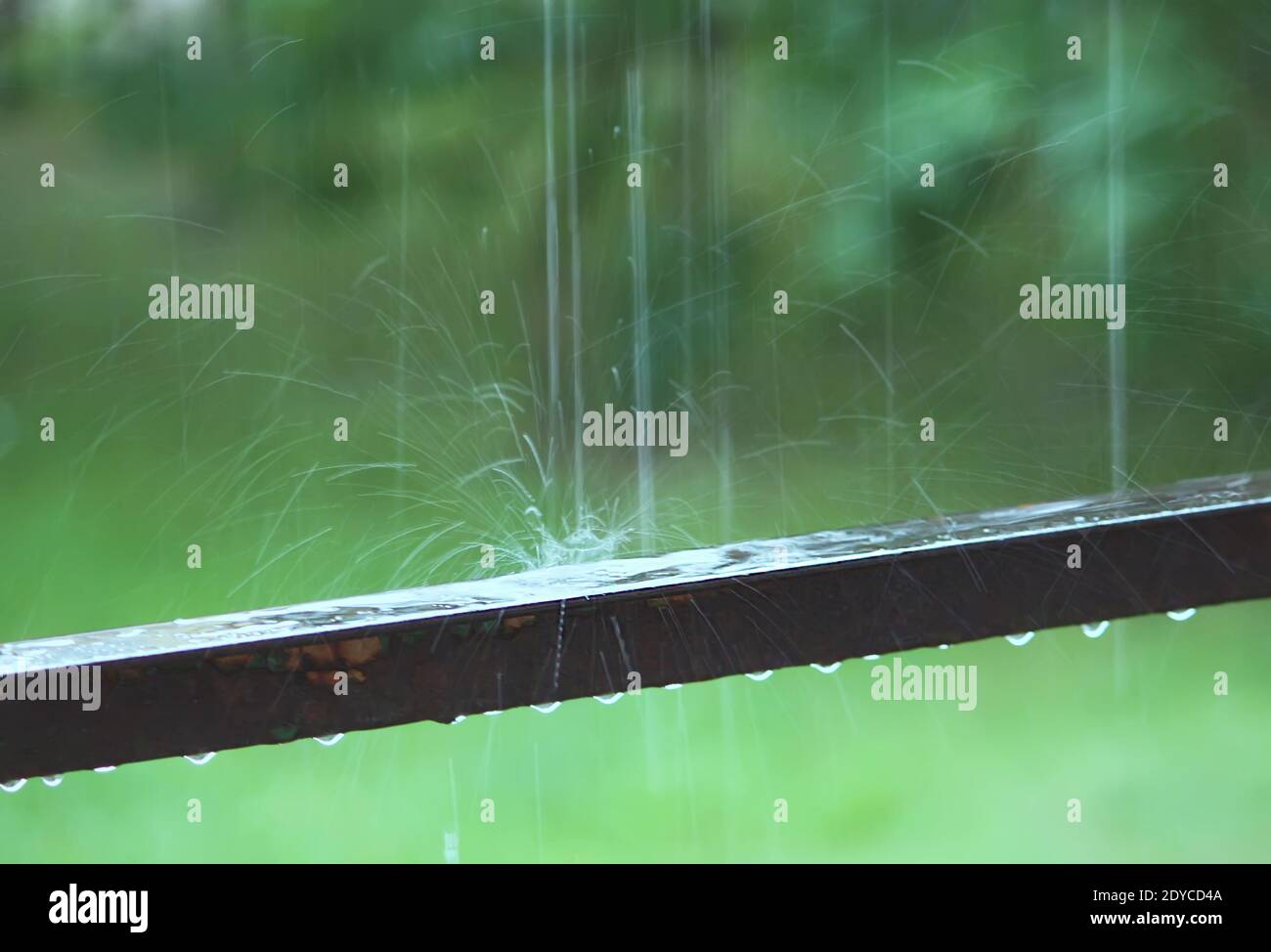 Splash of rain on the irin railings outdoors Stock Photo - Alamy