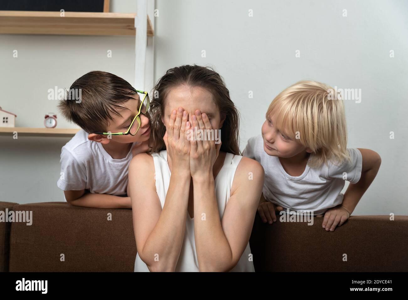 Sons comfort their upset mom. Children feel sorry for their crying ...