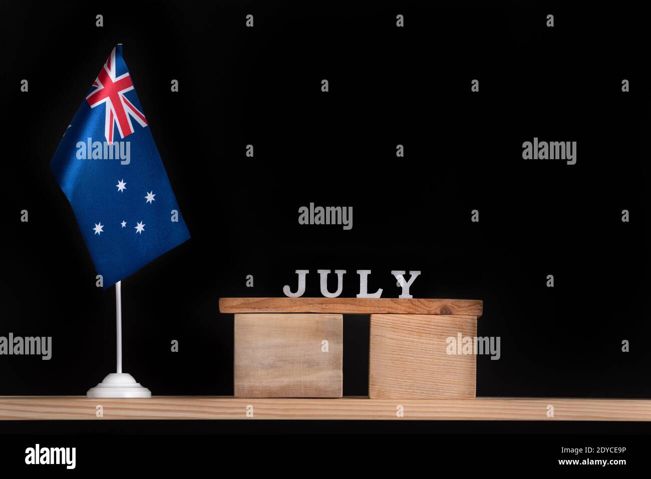Wooden calendar of July with Australian flag on black background ...