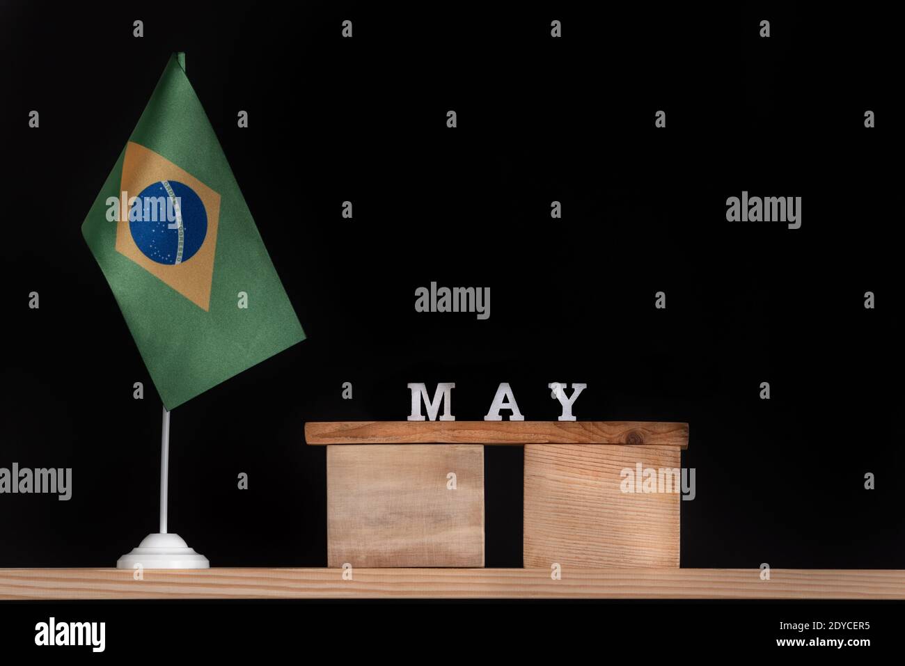 Wooden calendar of May with Brazilian flag on black background. Dates ...