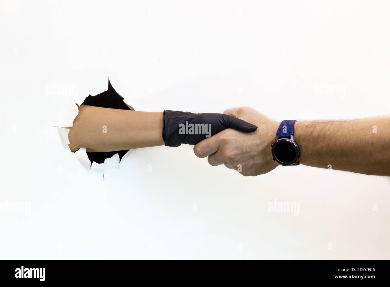 Female and male hands, one in a protective glove and the other without ...