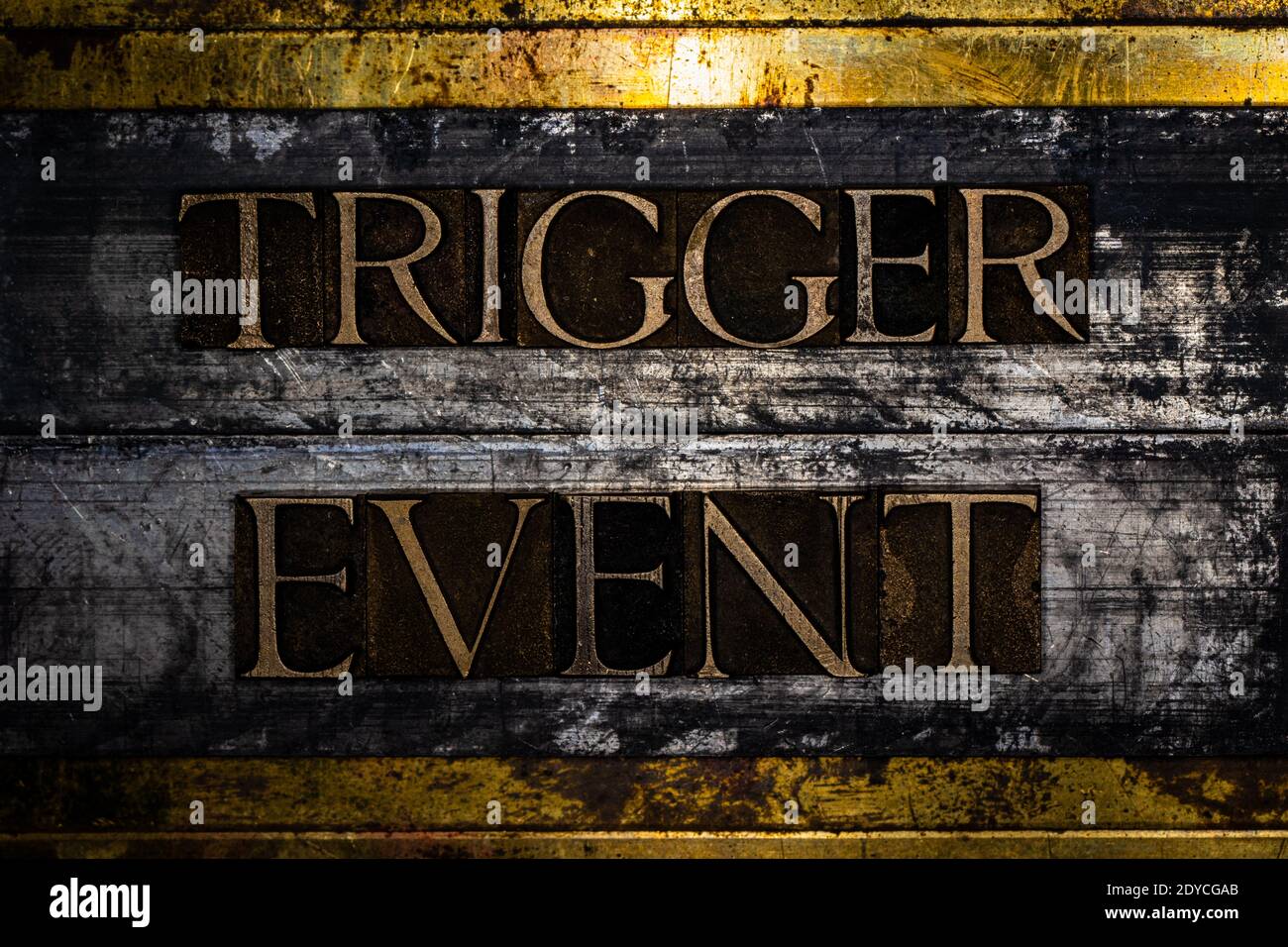 Trigger Event text on grunge textured copper and gold background Stock ...