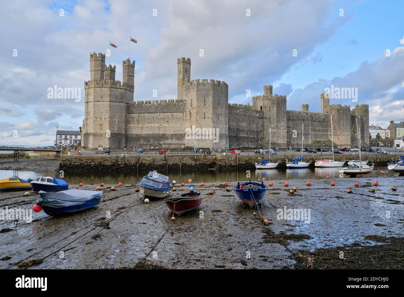 Caernarfon Castle at low tide, with boat sitting on silt out of water ...