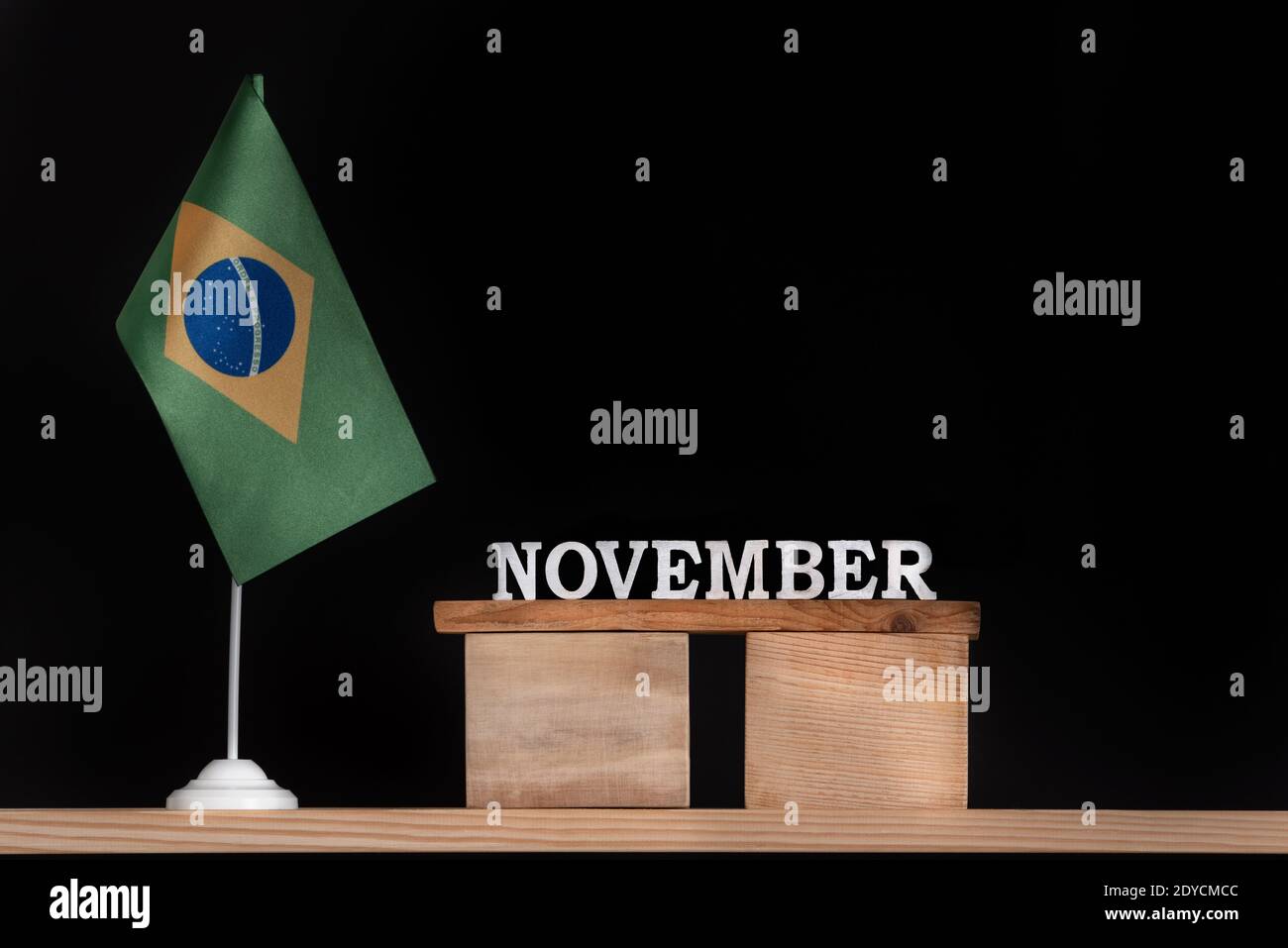 Wooden calendar of November with Brazilian flag on black background ...