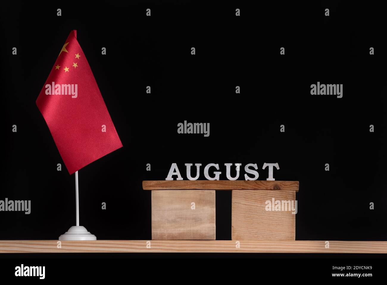 Wooden calendar of August with Chinese flag on black background ...