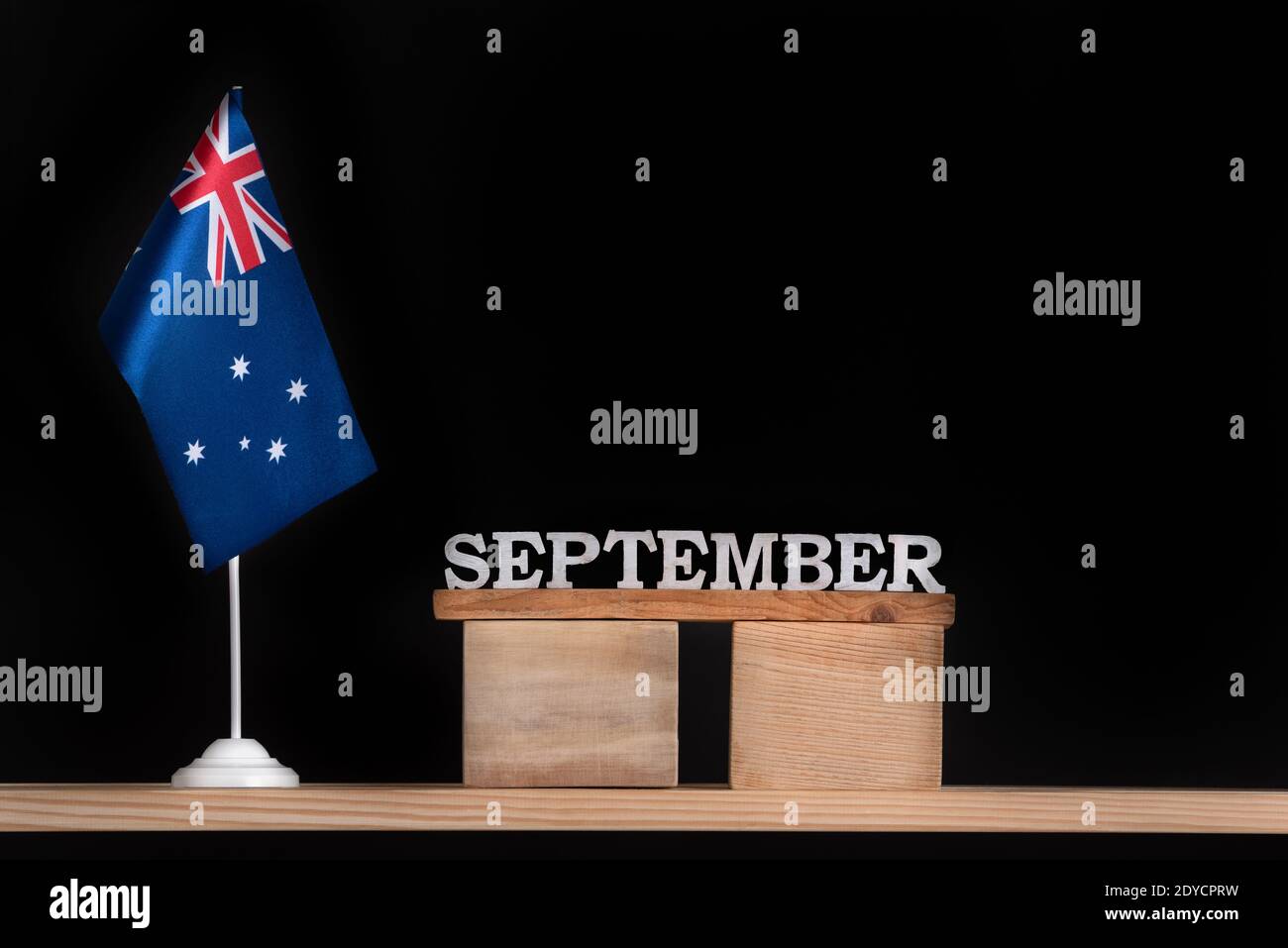Wooden calendar of September with Australian flag on black background ...