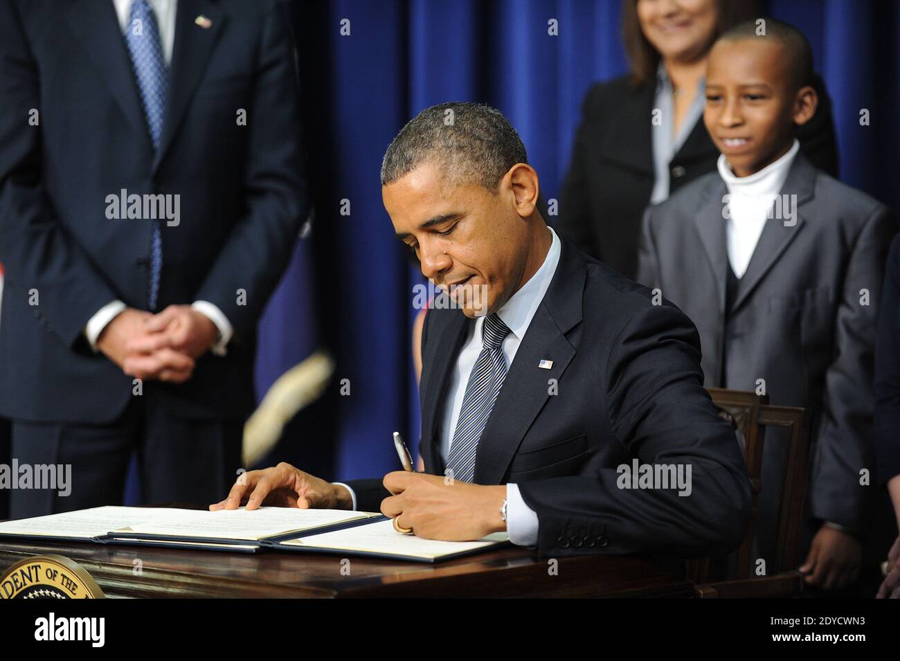 U.S. President Barack Obama signs a series of executive orders about ...