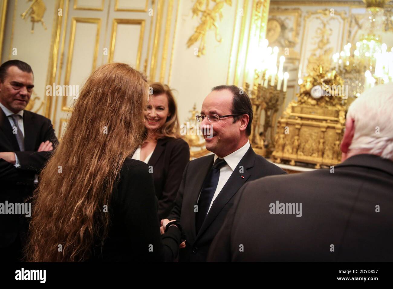 French president Francois Hollande, surrounded by lawyer Frank Berton ...