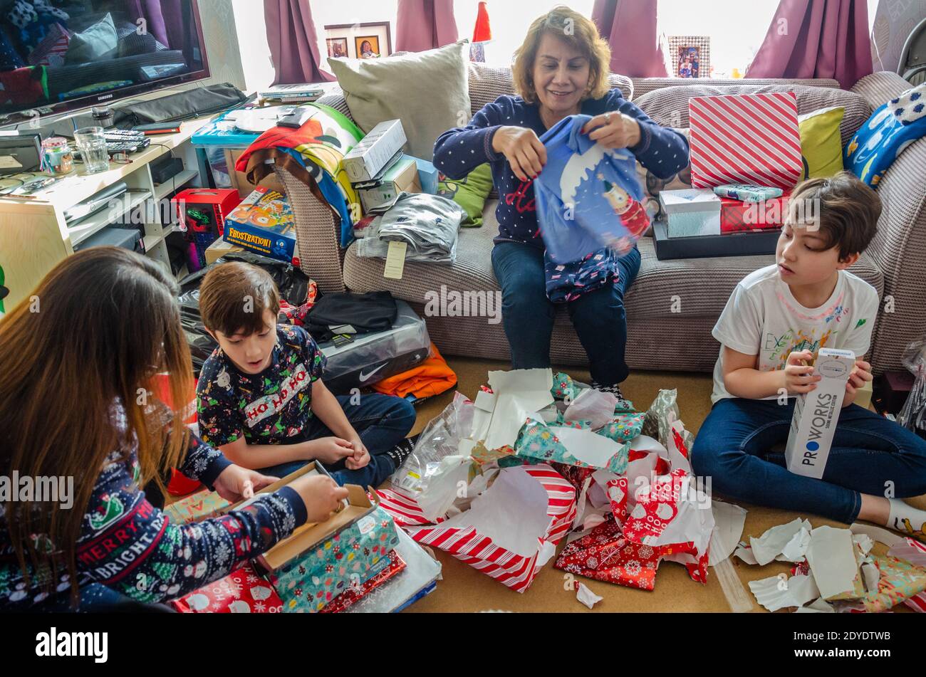 Unwrapping christmas presents children hi-res stock photography and ...