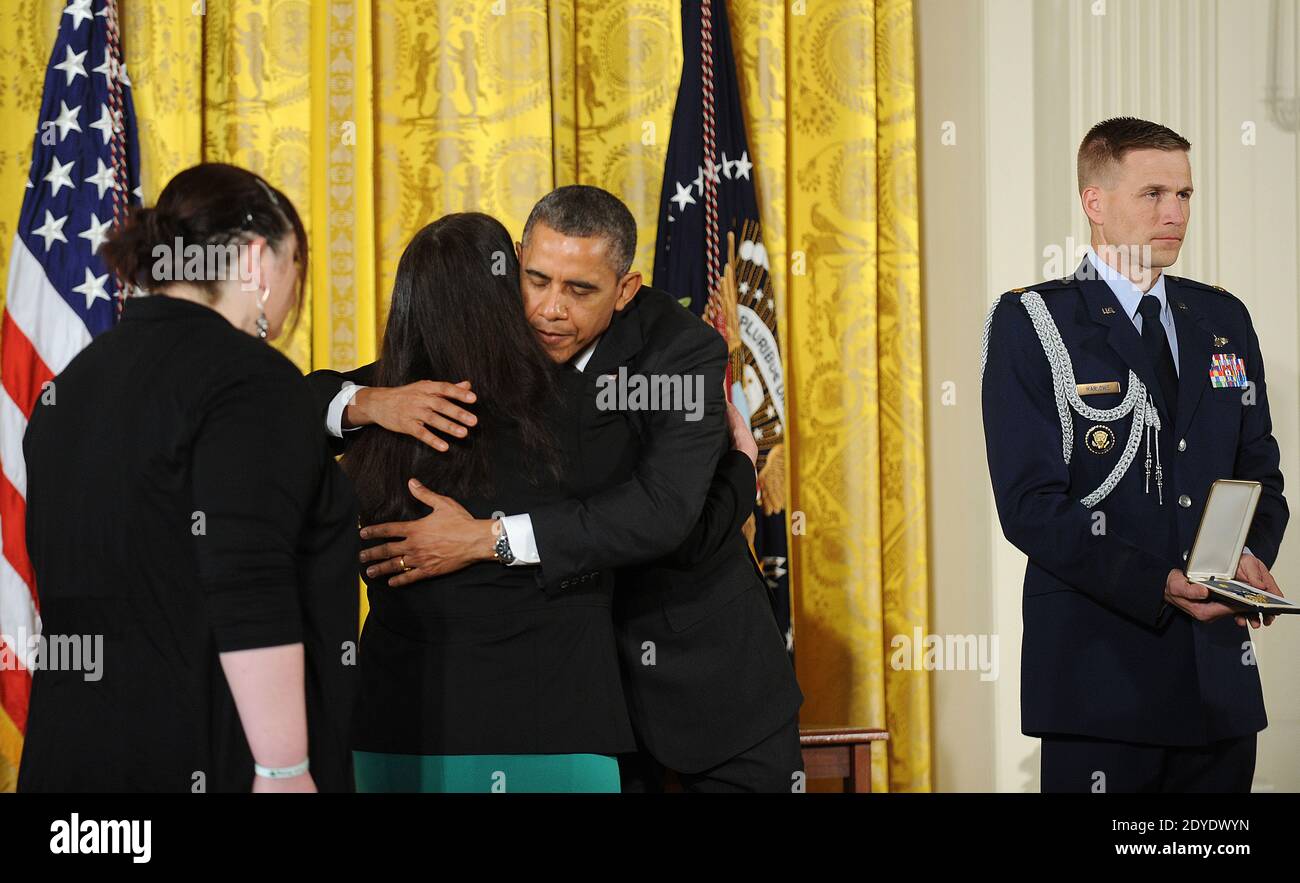 U.S. President Barack Obama embraces Mary and Sarah D'Avino before ...