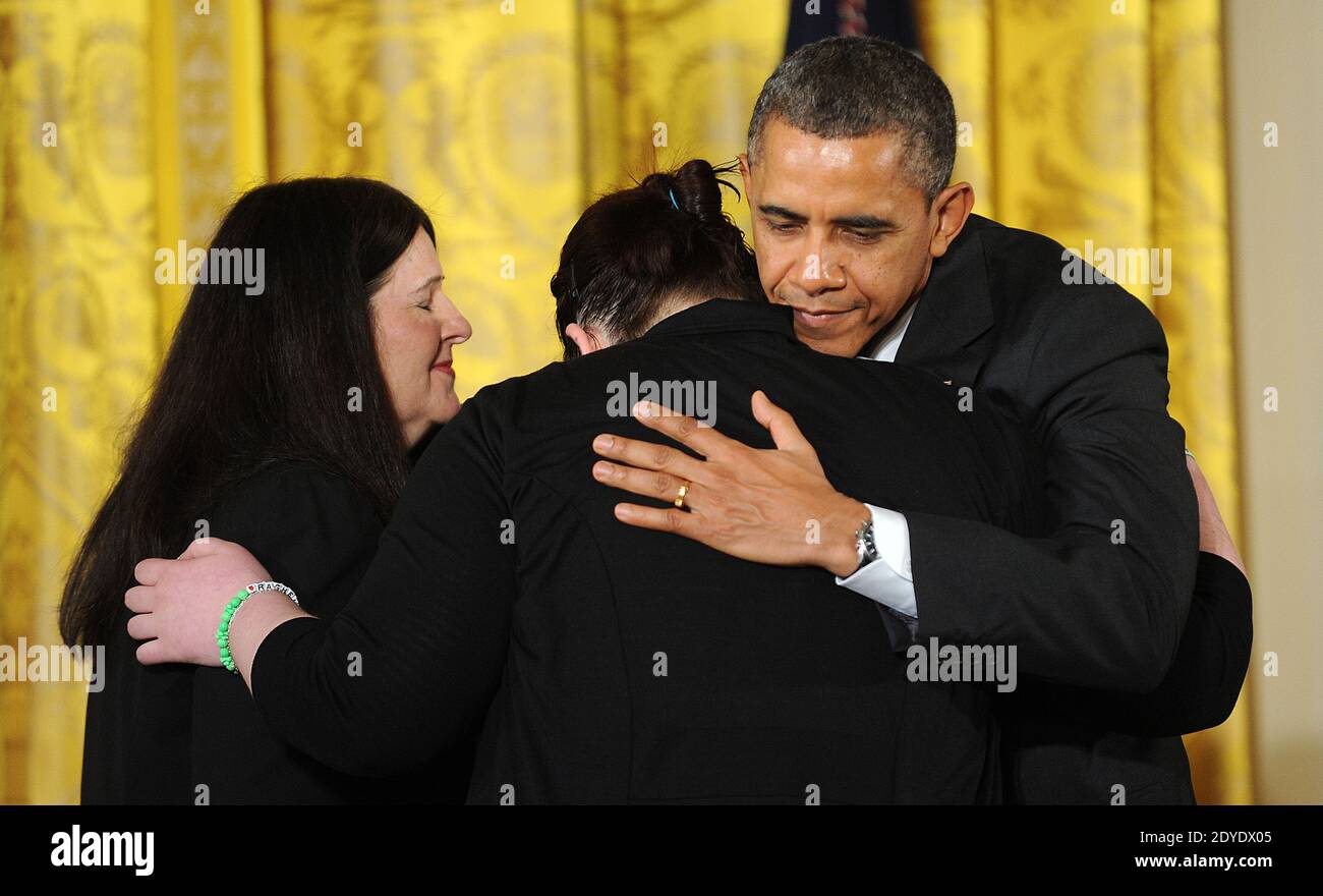 U.S. President Barack Obama embraces Mary and Sarah D'Avino before ...