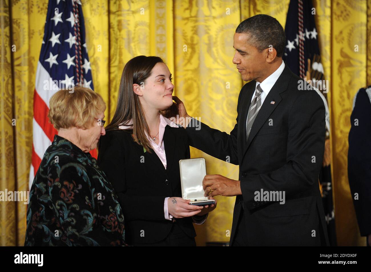 U.S. President Barack Obama presents Erica and Cheryl Lafferty with the ...
