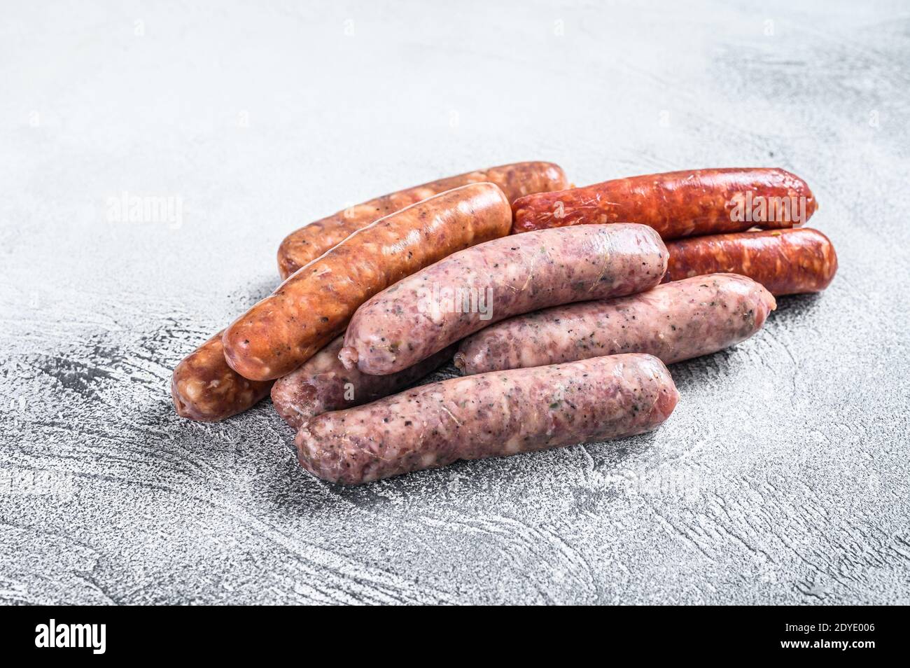Assorted raw chorizo sausages. White background. Top view Stock Photo ...