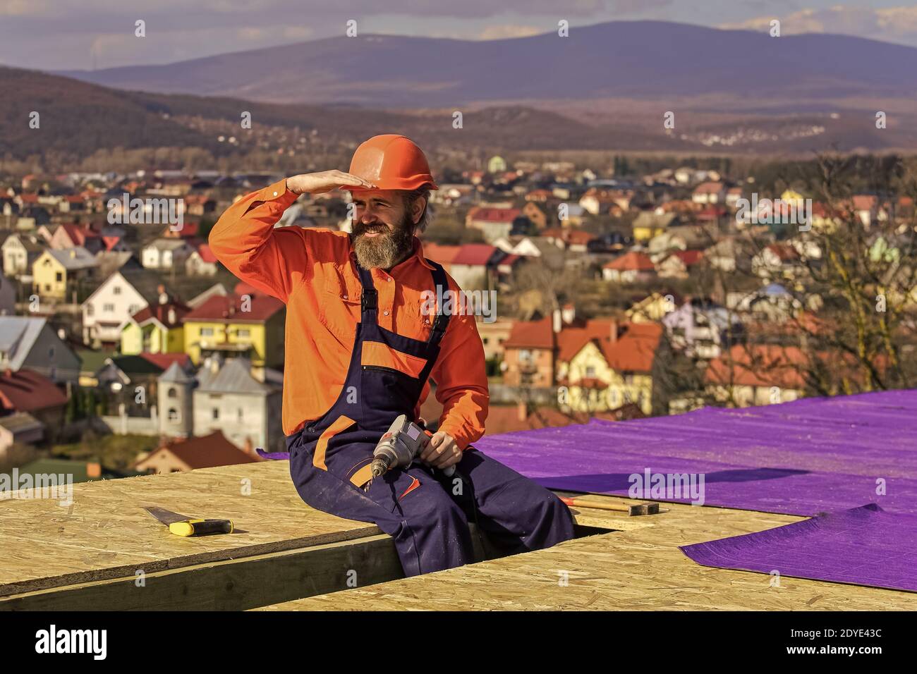 Roofer constructing roof. Master repair roof. Flat roof installation ...