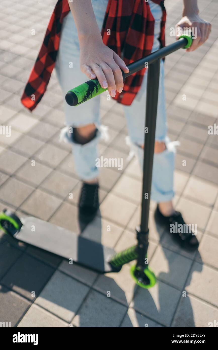 young teenager in sneaker on modern extreme stunt kick scooter in ...