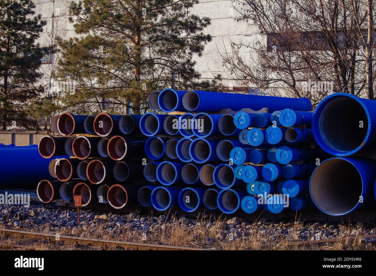 Stack of cast iron pipes in loading area waiting for transportation ...