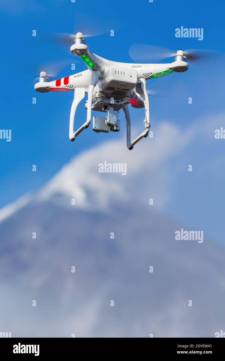 Flying UAV drone quadcopter aerial videography in sky on background ...