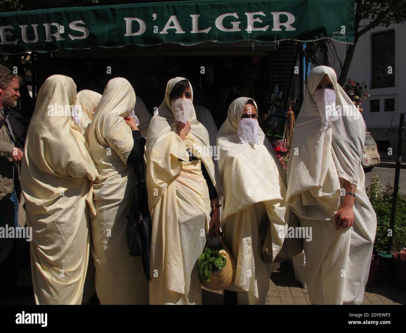 Algerian women wearing their traditional islamic outfits take part in a ...