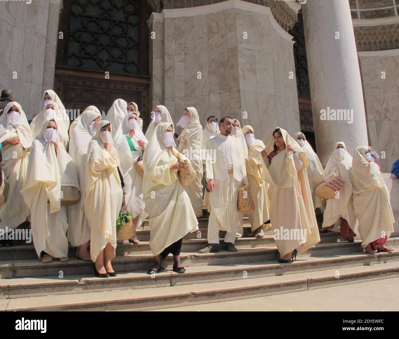 Algerian women wearing their traditional islamic outfits take part in a ...