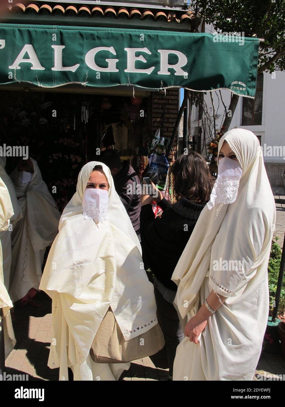 Algerian women wearing their traditional islamic outfits take part in a ...