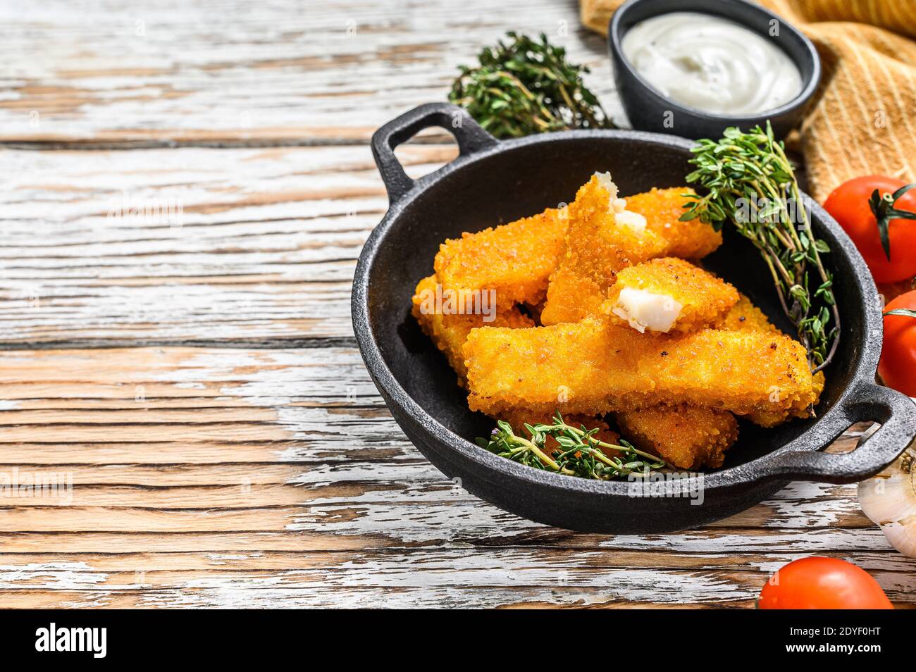 Oven baked crumbed fish sticks made from white fish. White background ...