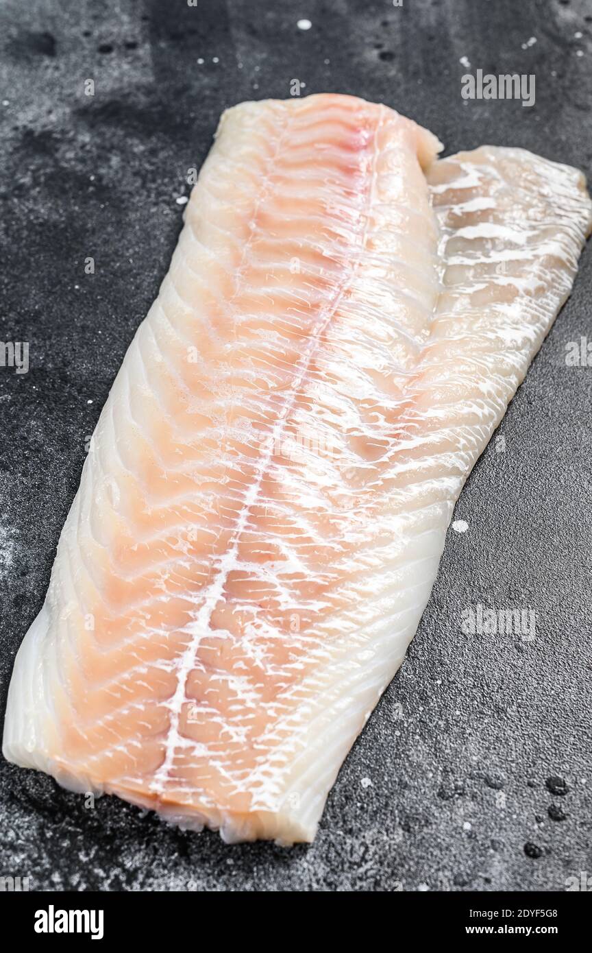Raw Norwegian skrei cod fish fillet. Black background. Top view Stock ...