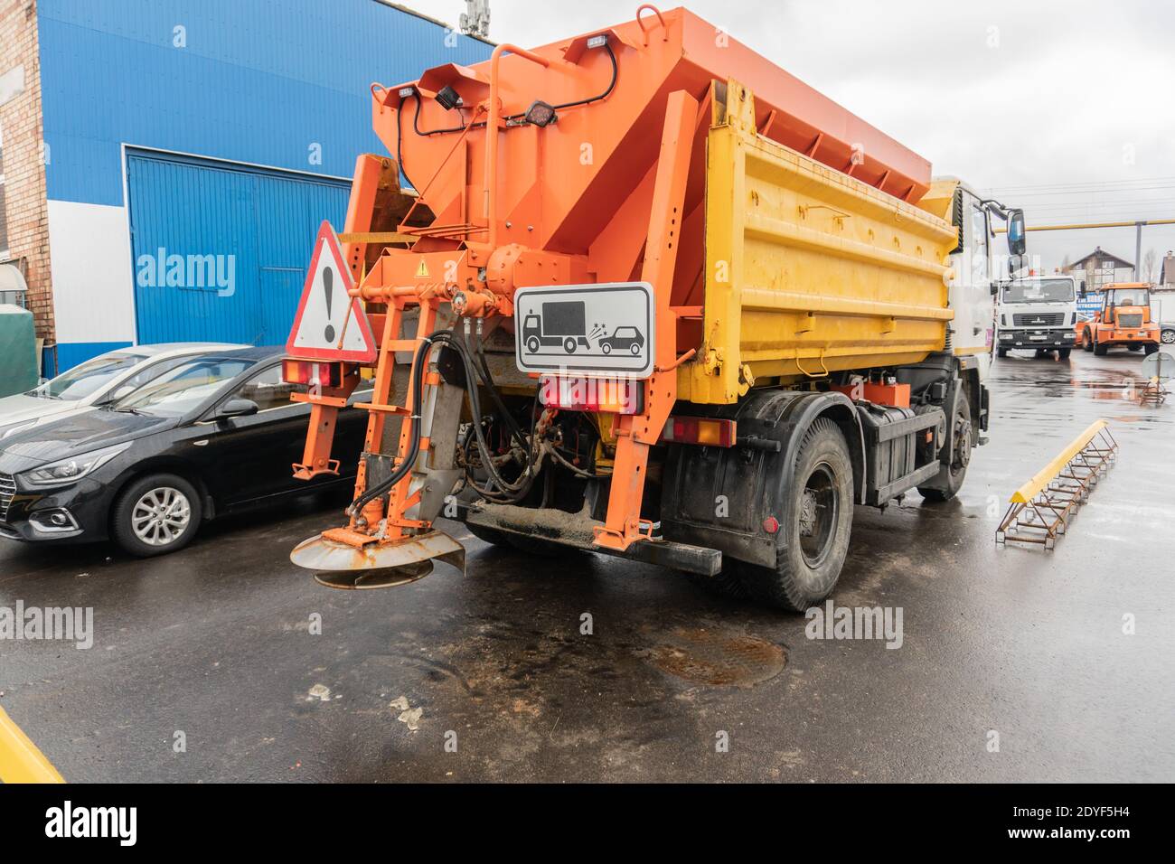 The machine that sprinkles salt on the road in winte Stock Photo - Alamy