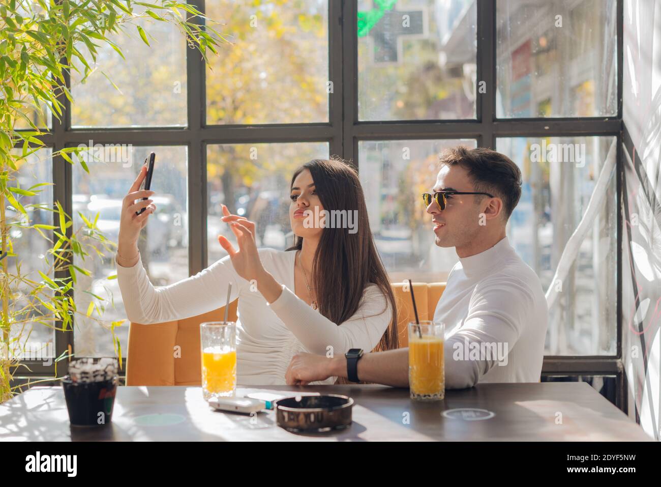 Friends socializing, having fun, and laughing drinking coffee in ...