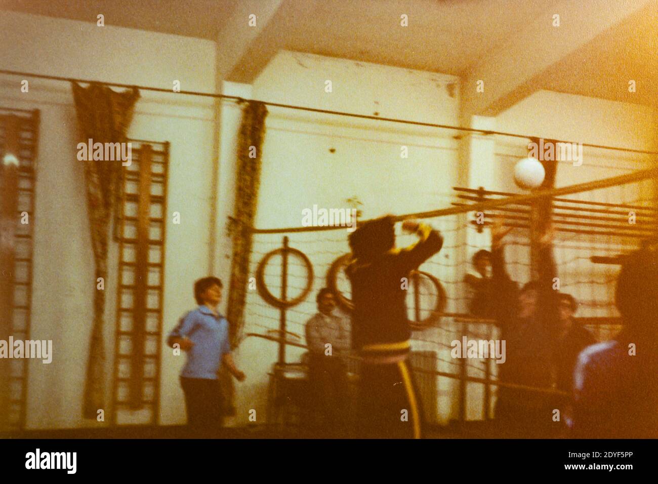 MILAN, ITALY 18 AUGUST 1975: Kids play volleyball in the school gym ...