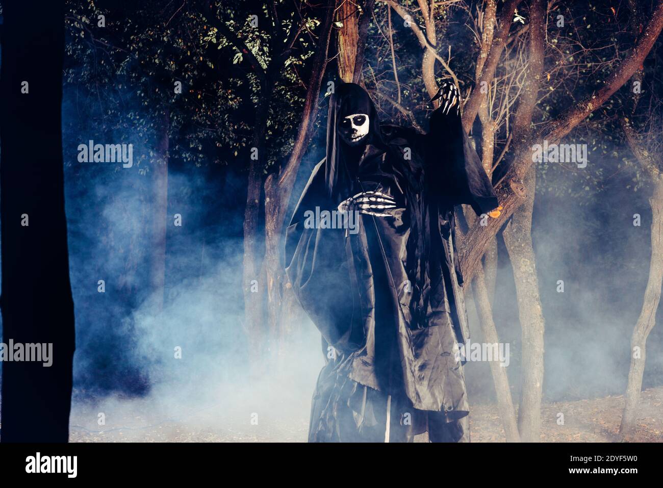 Portrait of the angel of death, grim reaper while standing in a ...