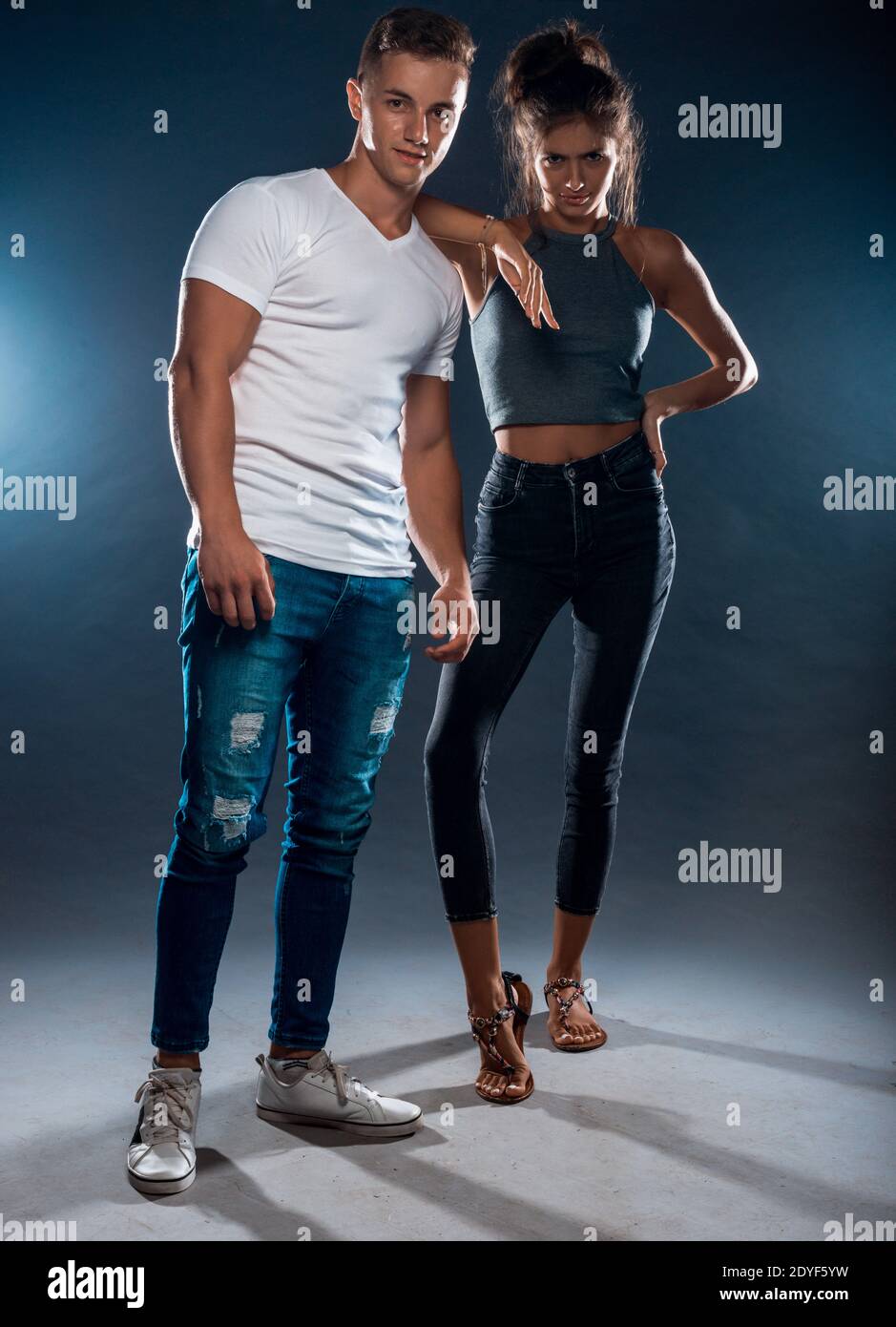 Body shot of attractive male and female models posing in modern clothes ...