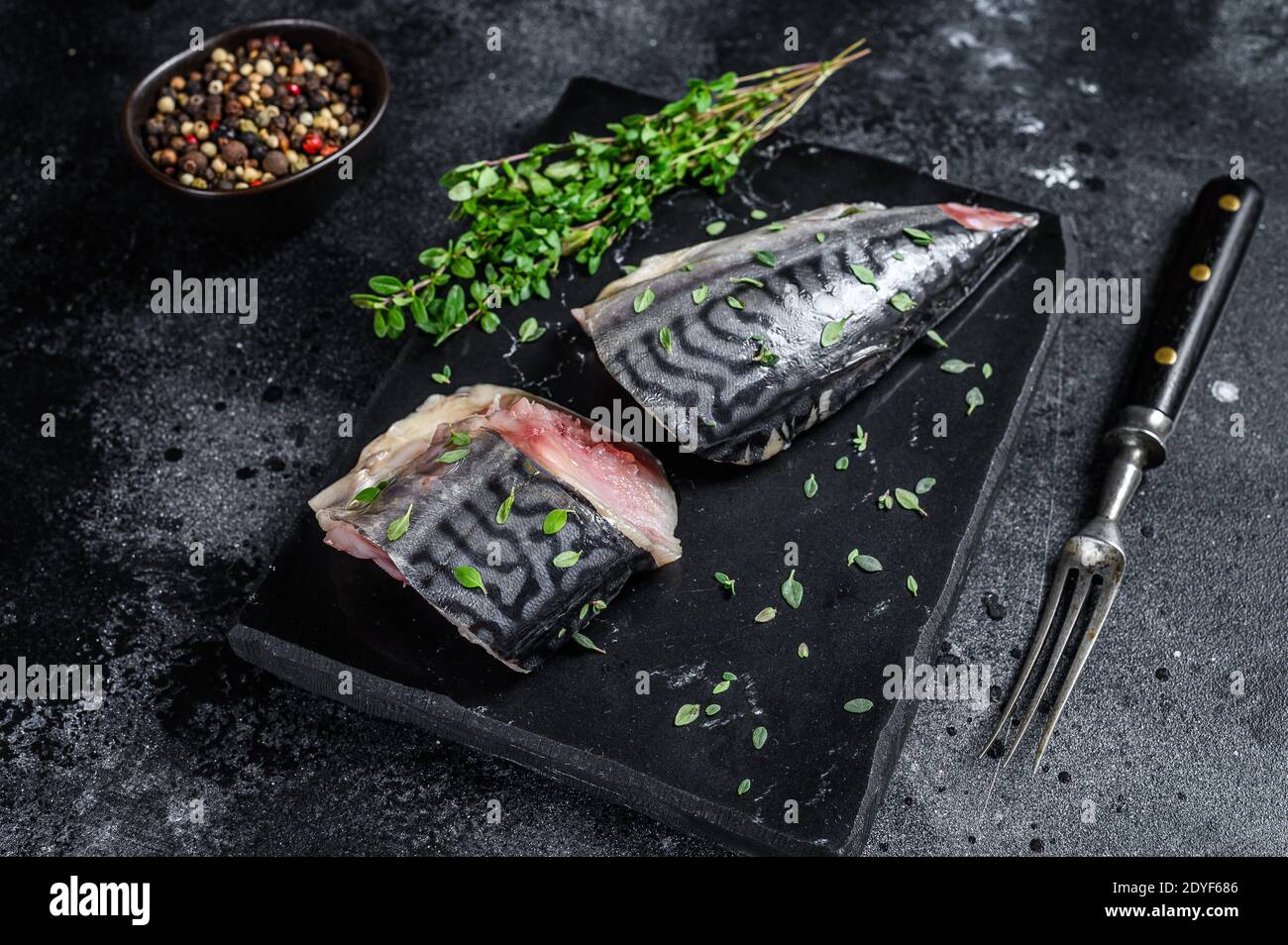 Cold smoked mackerel fish with herbs. Black background. Top view Stock ...