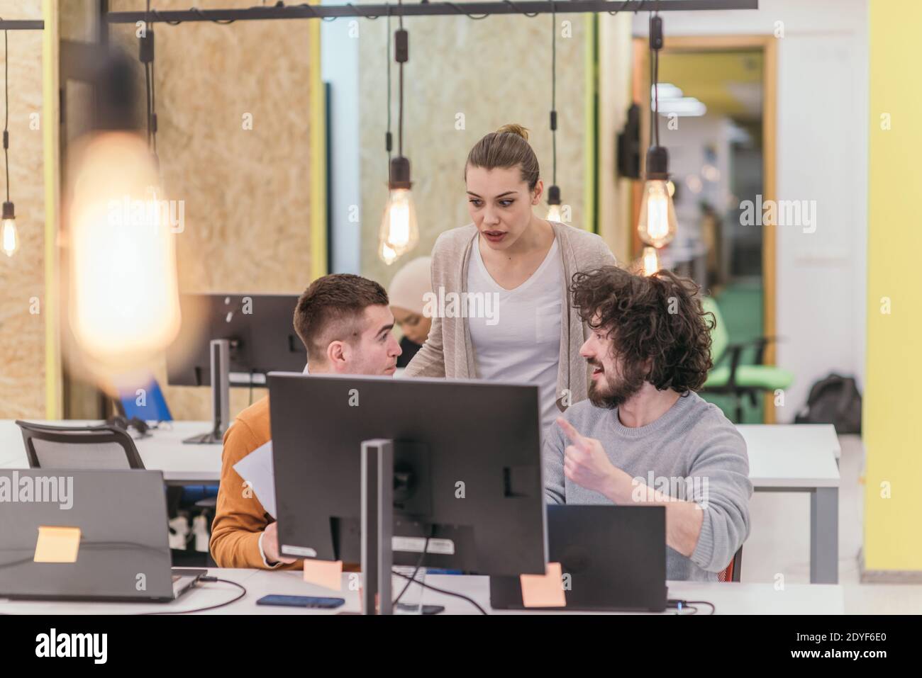 Group of coworkers, colleagues having fun at the office while chatting ...