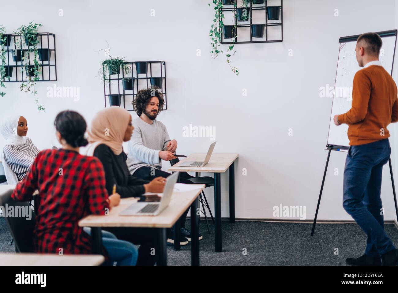 Modern business team listening to the company speaker during a lecture ...