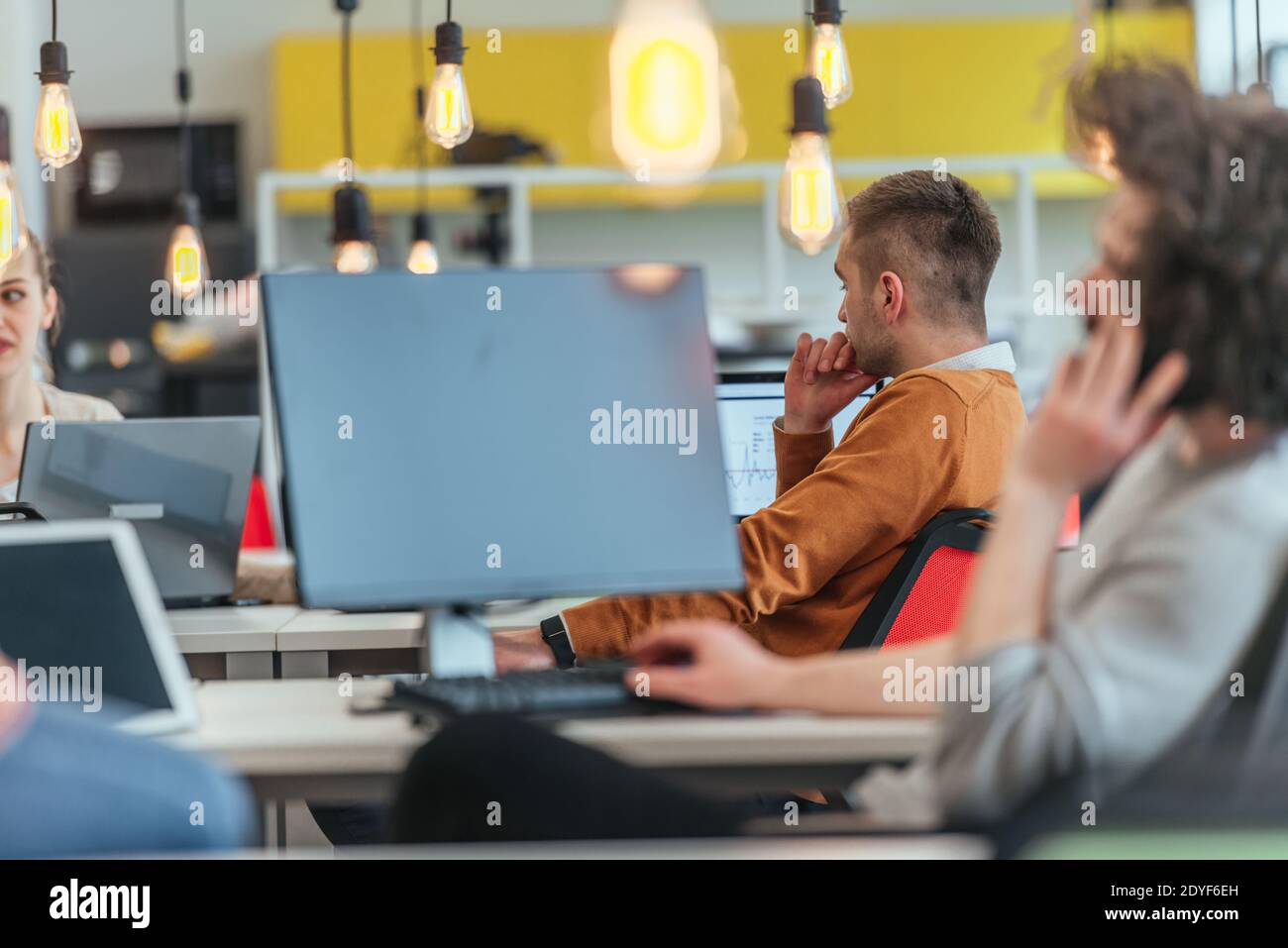 Bearded employee guy with afro haircut talking on his phone while being ...