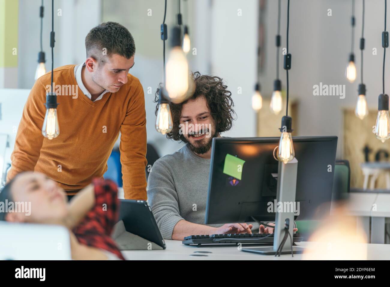 Portrait of two busy colleagues working on pc economy project on modern ...