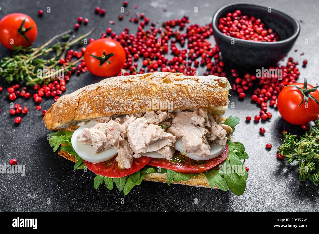 Sandwich with cod liver pate, arugula, tomato, egg and herbs. Black ...